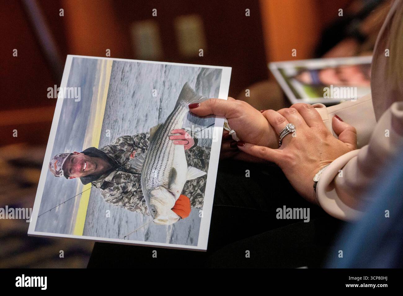 Sarah Boyd holds a photo of her husband Jonathan Boyd who perished on ...
