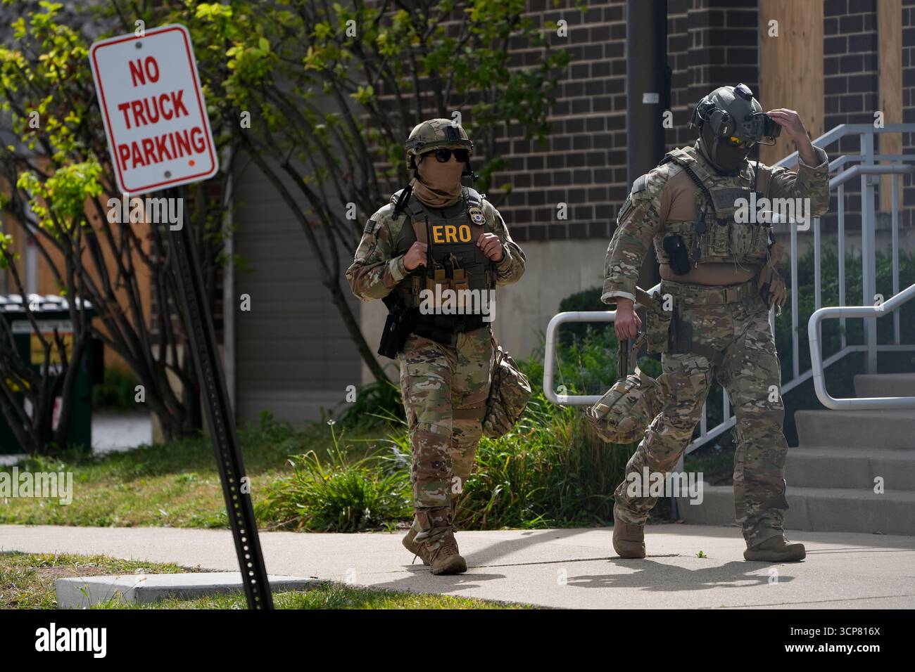 Enforcement and Removal Operations agents walk outside the U.S ...