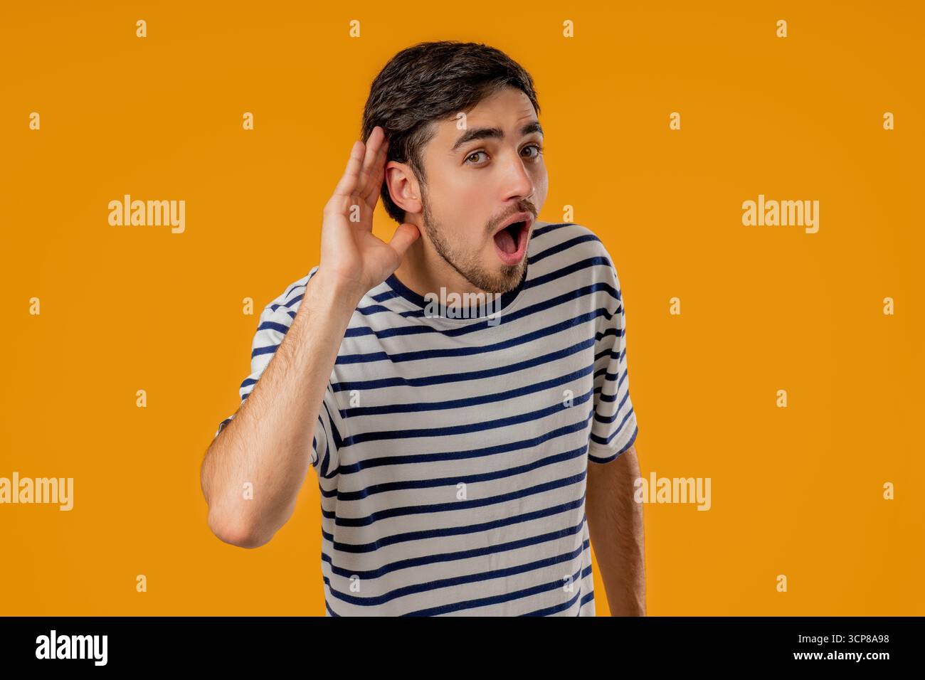Young Man Pointing To Ear With Confused Face, Signaling He Cant Hear ...