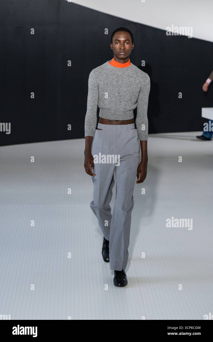 Model Ojo Emmanuel is seen on the catwalk at the Jil Sander fashion ...