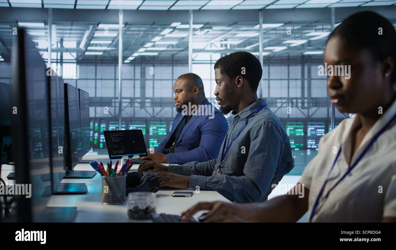 System administrators in data center implementing AI predictive maintenance systems. Teamworking ...