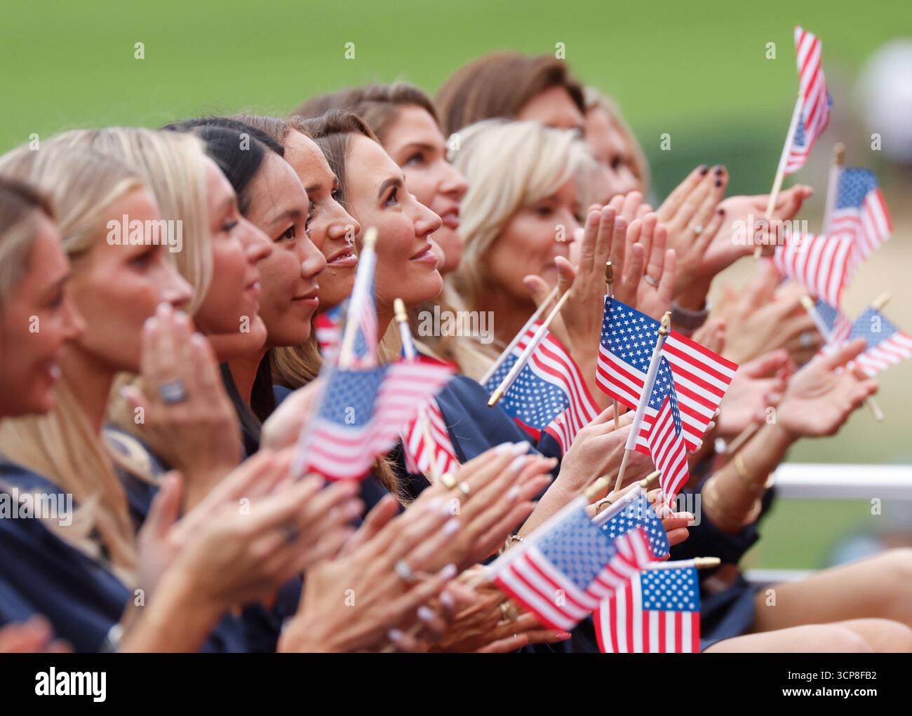 The wives and partners of Team United States golfers hold American ...