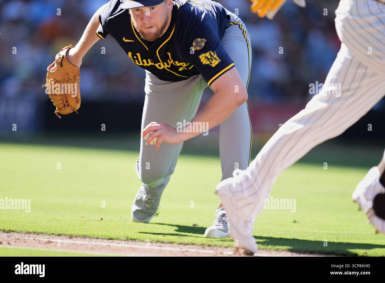 Milwaukee Brewers relief pitcher Jared Koenig fields a ground ball as ...