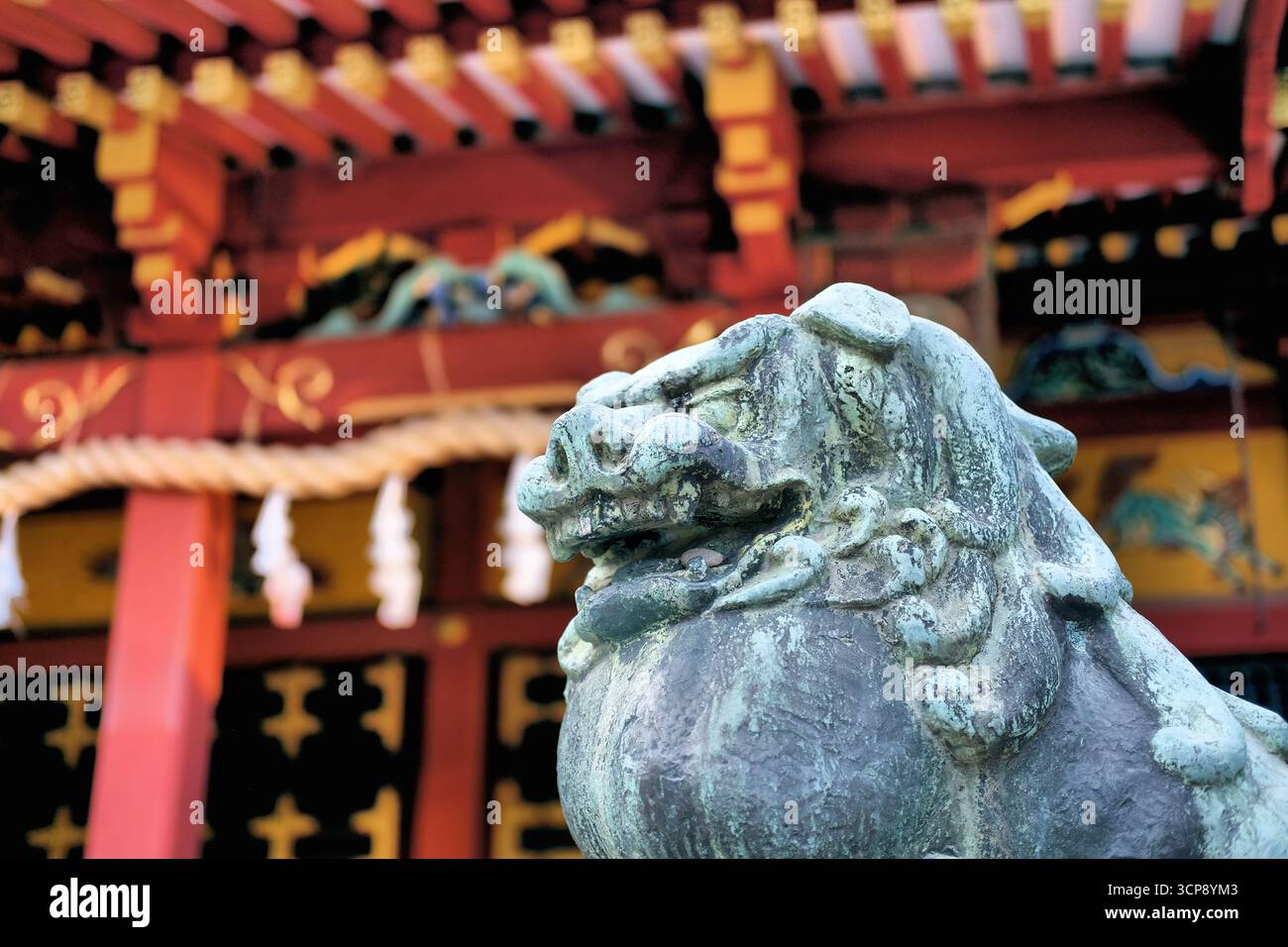 Stone komainu lion dog guarding the entrance at the Senso-ji Temple and ...