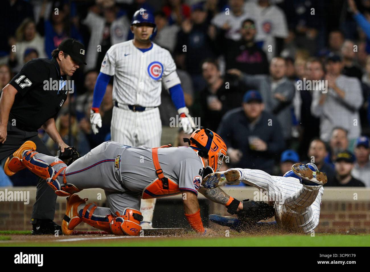 New York Mets catcher Francisco Alvarez, left, tags out Chicago Cubs ...