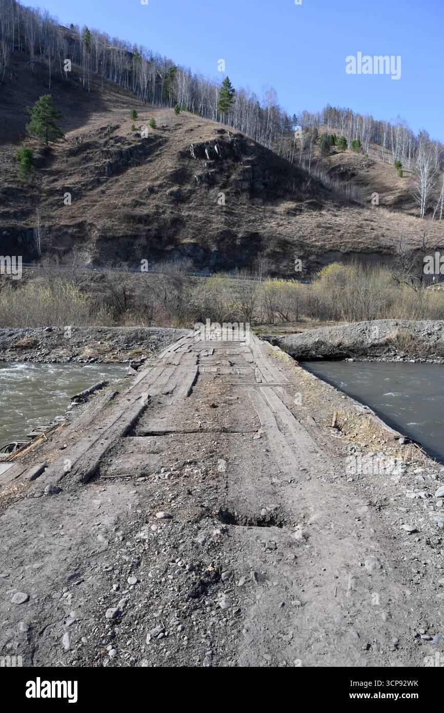 Sema River and an old wooden bridge at the foot of a mountain with a ...