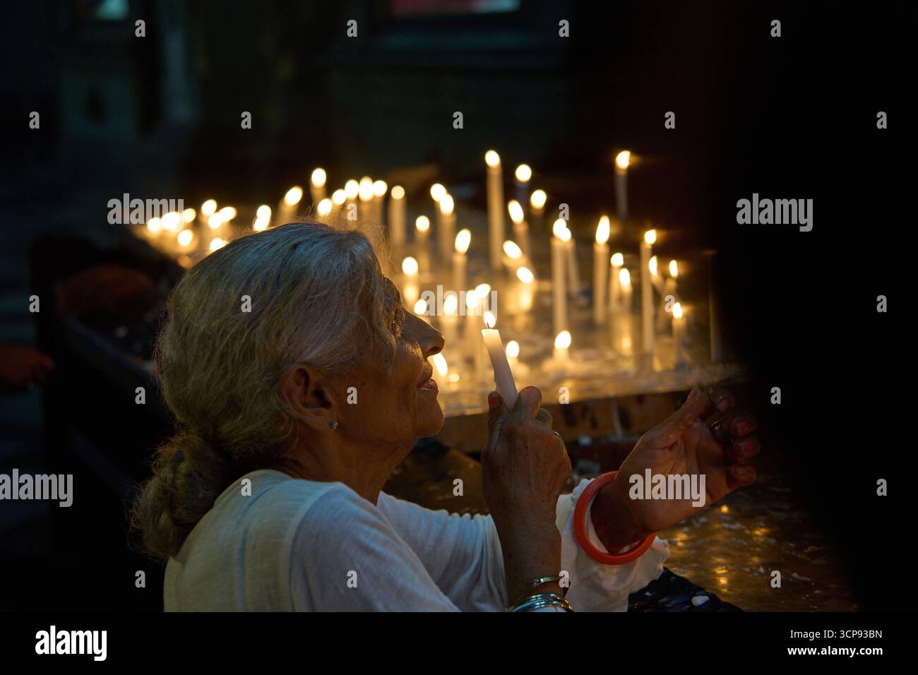 A woman prays during Mass commemorating Our Lady of Mercy in Havana ...