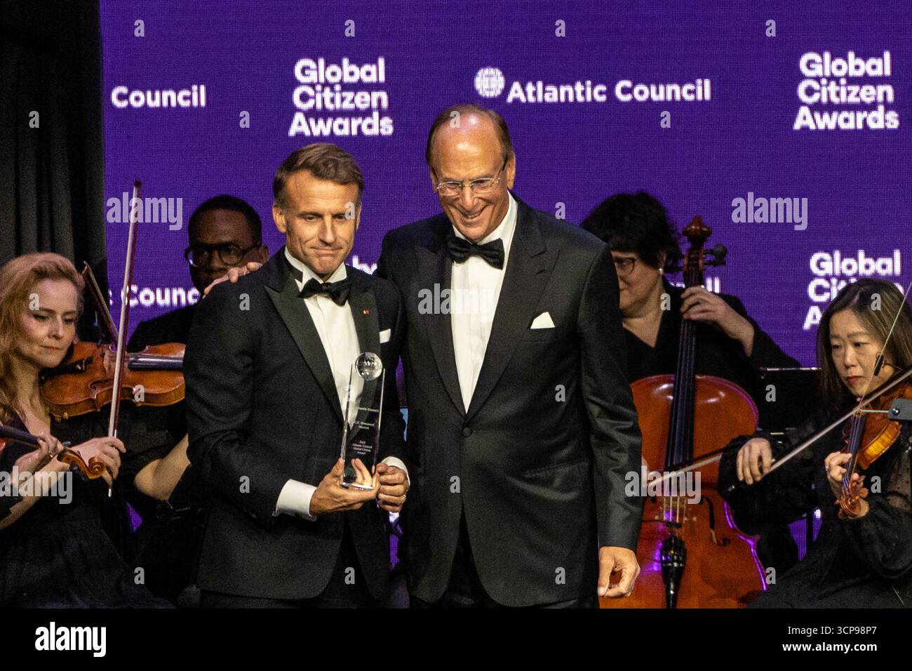 President of France Emmanuel Macron receives an award from Laurence ...