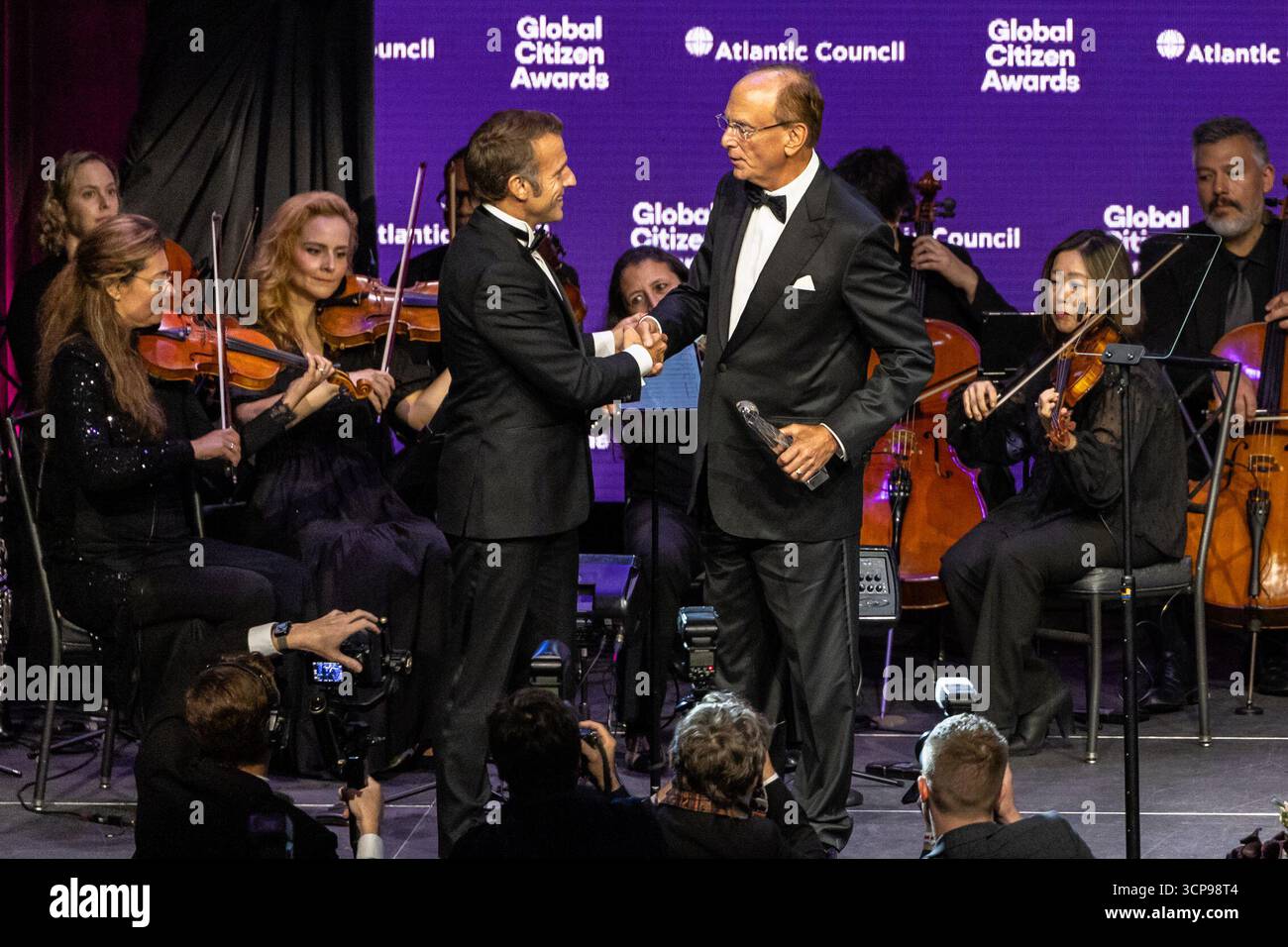 President of France Emmanuel Macron receives an award from Laurence ...