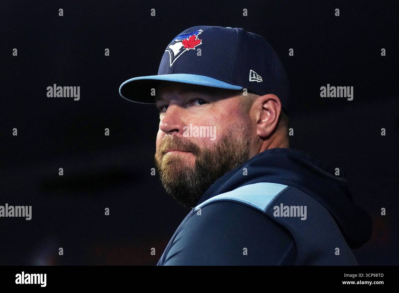 Toronto Blue Jays manager John Schneider (14) looks out from the dug ...