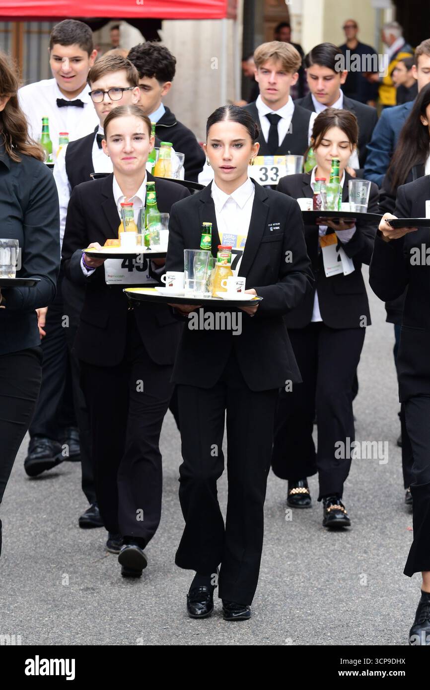 Waitresses carry trays with drinks during the waiters race. Waiters ...