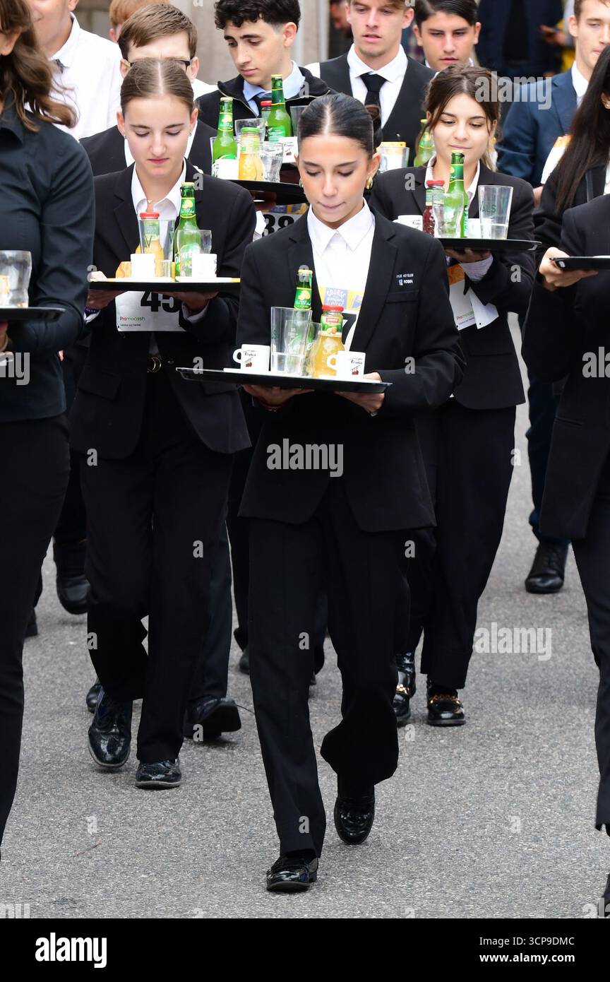 Waitresses carry trays with drinks during the waiters race. Waiters ...