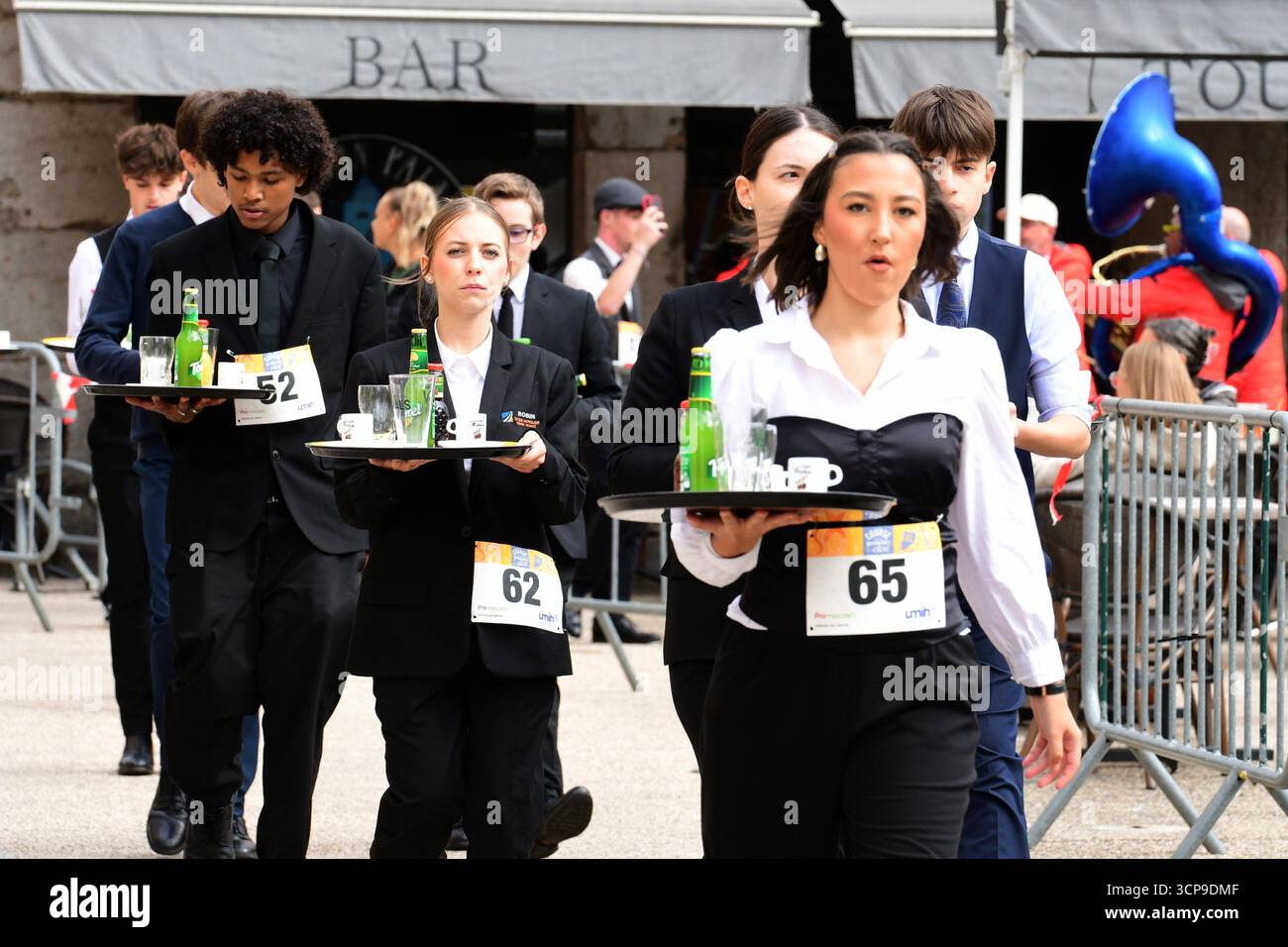 Waitresses carry trays with drinks during the waiters race. Waiters ...