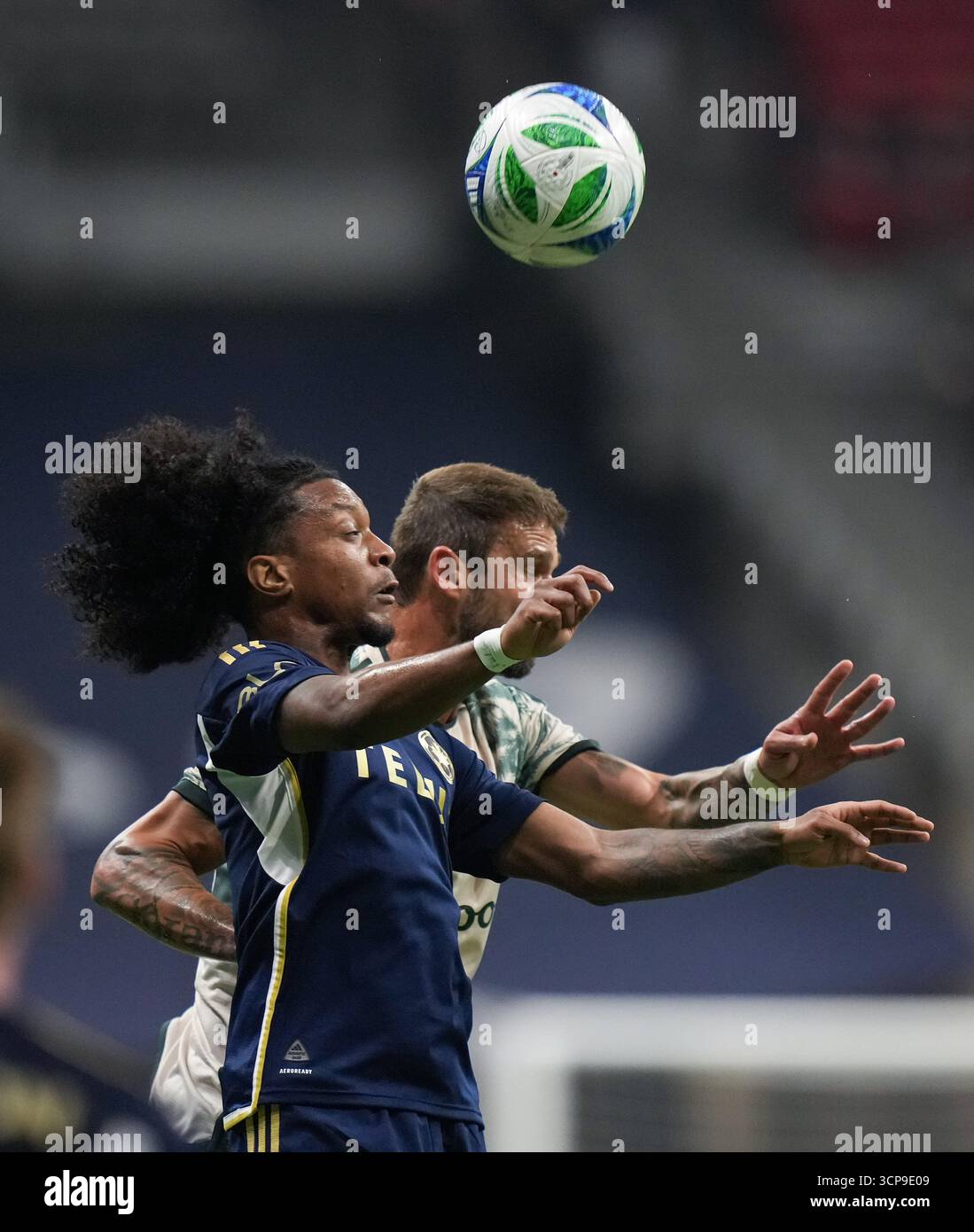 Vancouver Whitecaps' Jayden Nelson, front left, and Portland Timbers ...