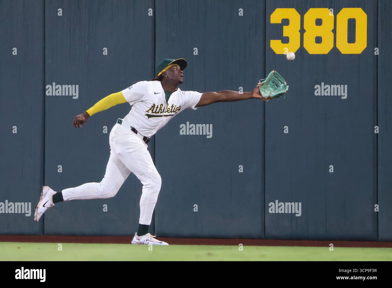 Athletics center fielder Lawrence Butler attempts to catch a fly ball ...