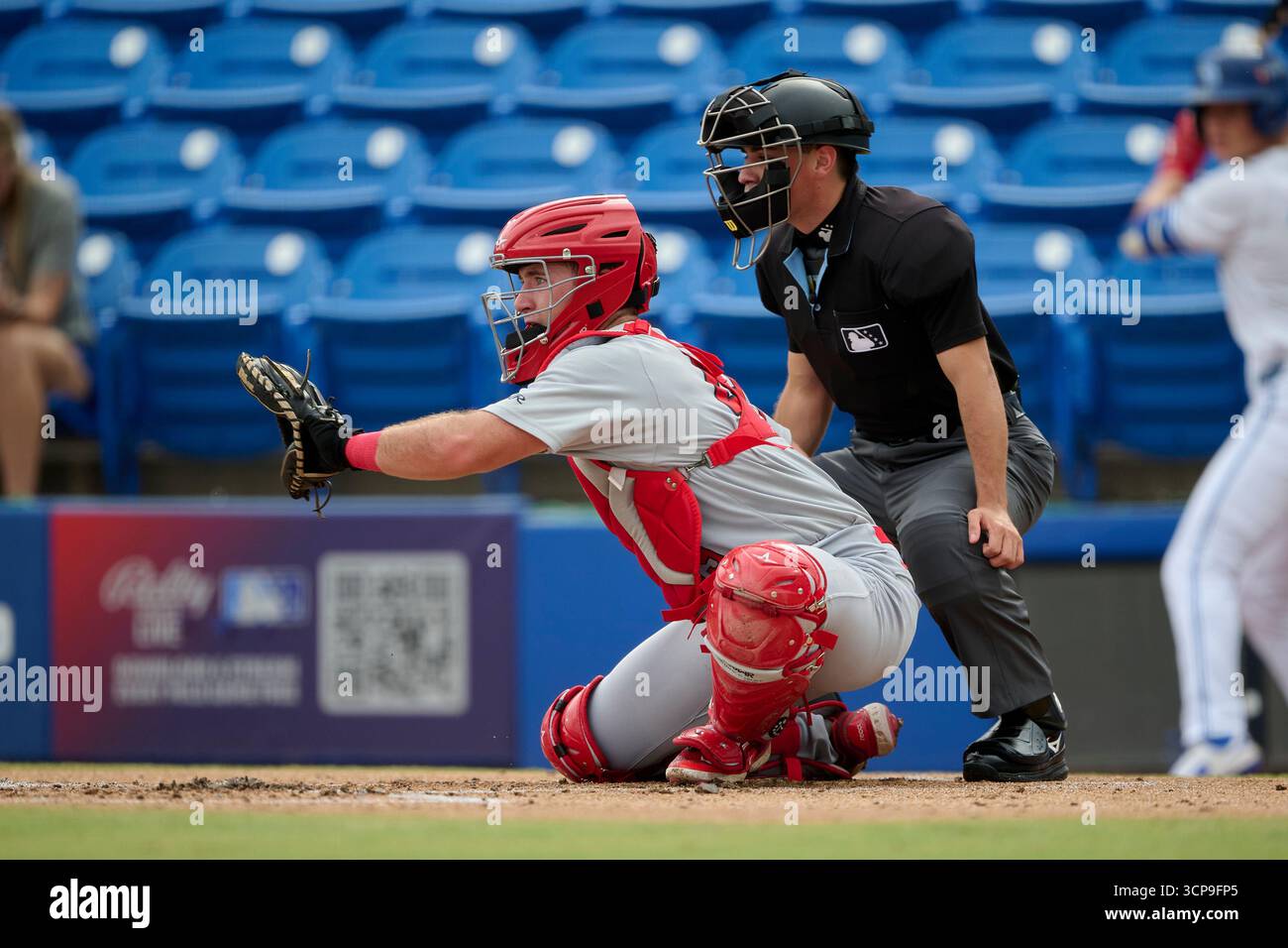 Umpire Francisco Gonzalez and Palm Beach Cardinals catcher Chase Heath ...