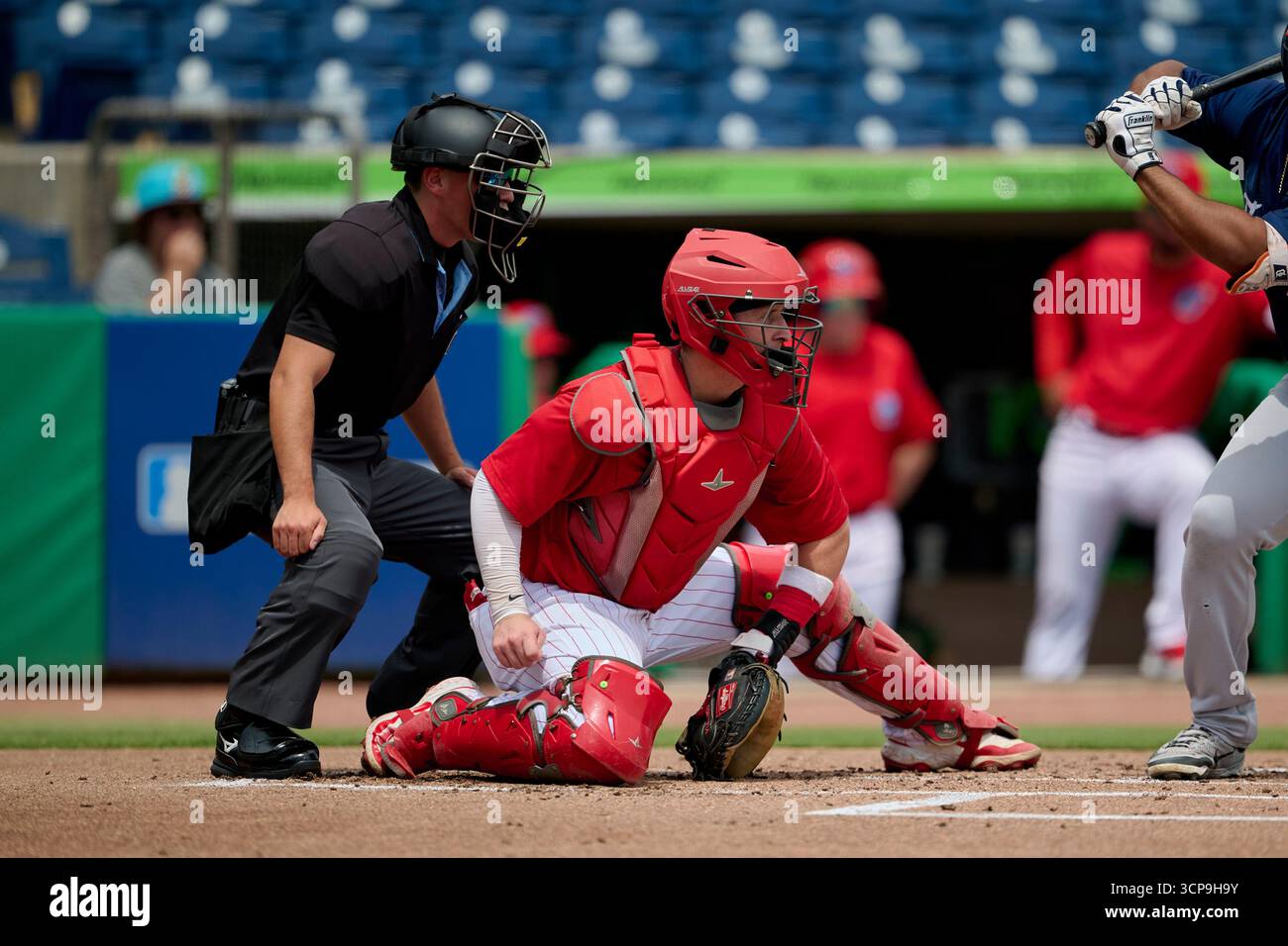 Umpire Francisco Gonzalez and Clearwater Threshers catcher Luke Davis ...
