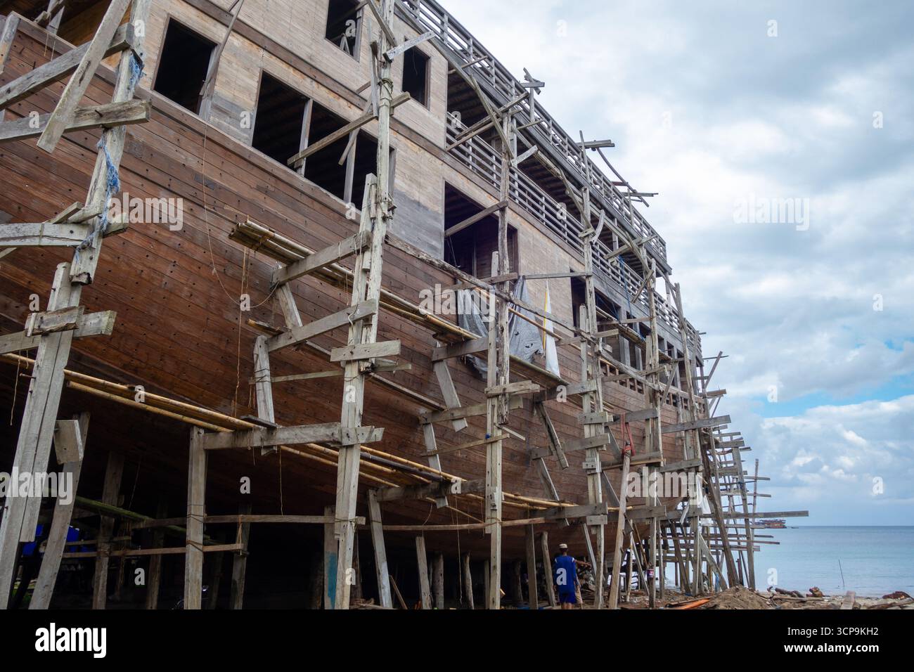 Wooden boats are built by hand at the Tana Beru shipyard in Sulawesi ...