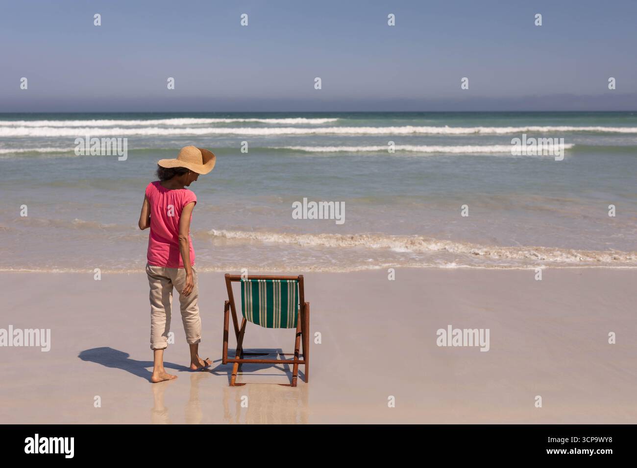 Woman wearing striped top waves hi-res stock photography and images - Alamy