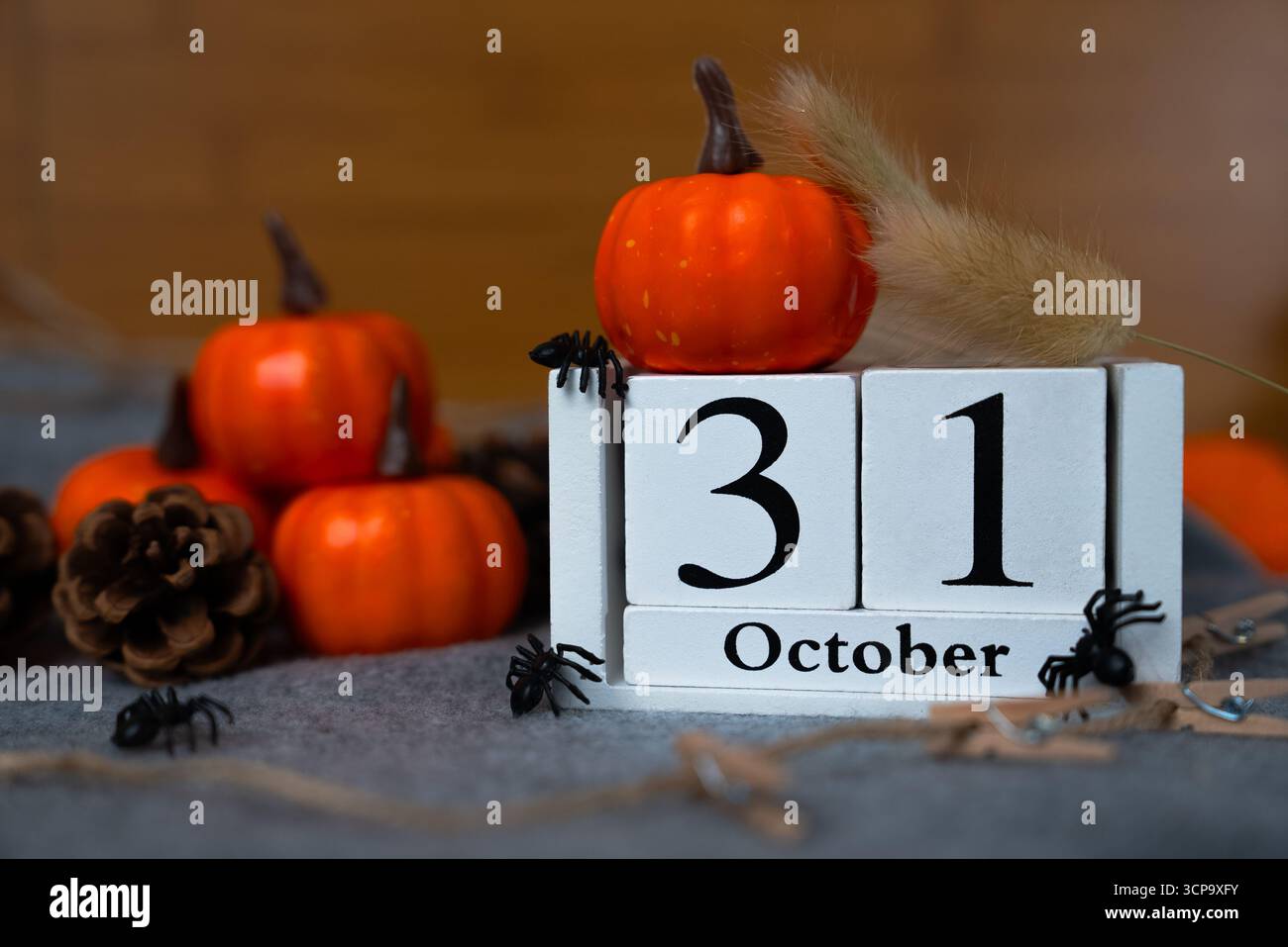 Rustic scene with 31 October calendar cubes, tiny pumpkins and natural ...