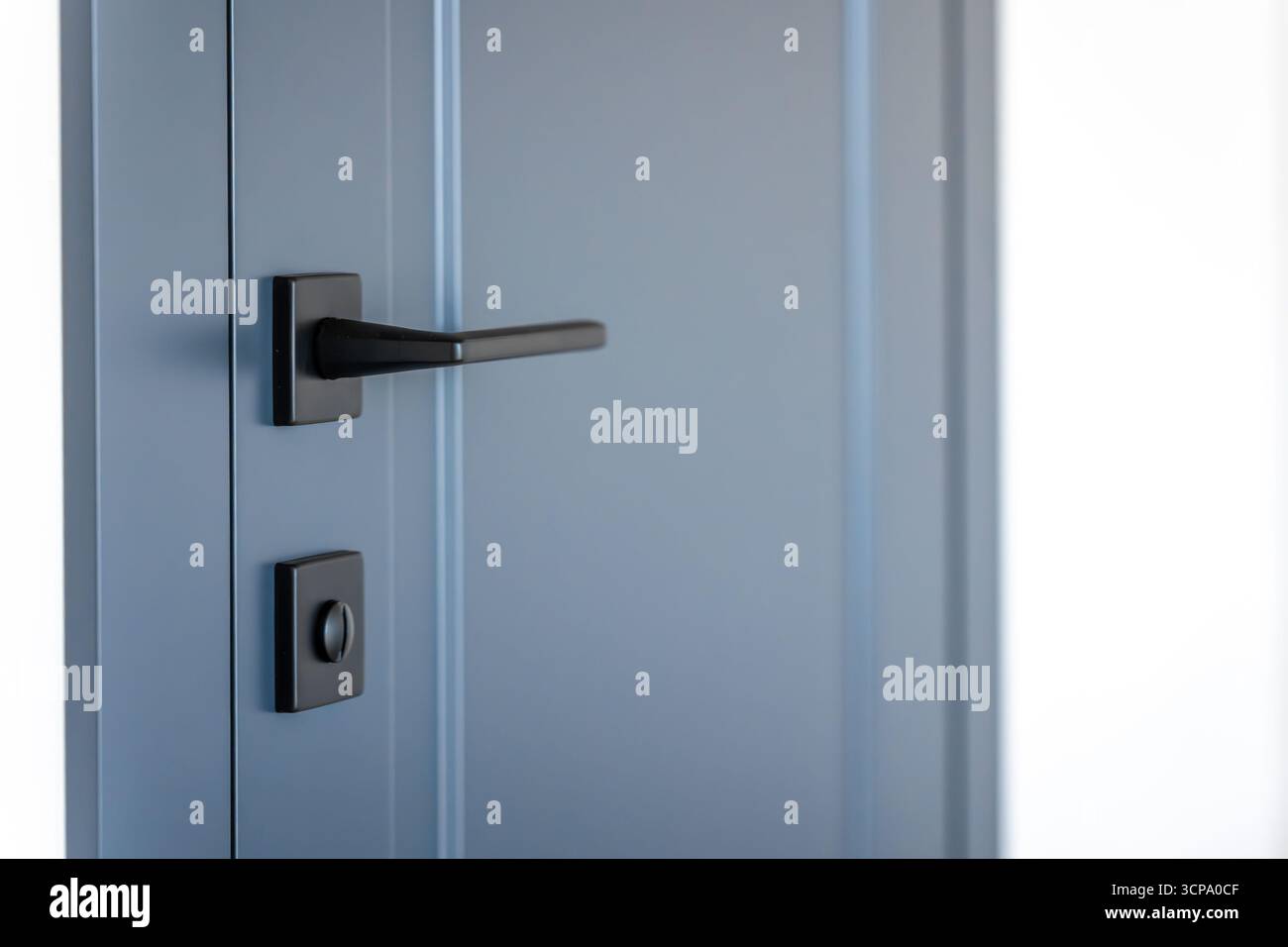Blue interior door. Sleek handle. Light minimalism Stock Photo - Alamy