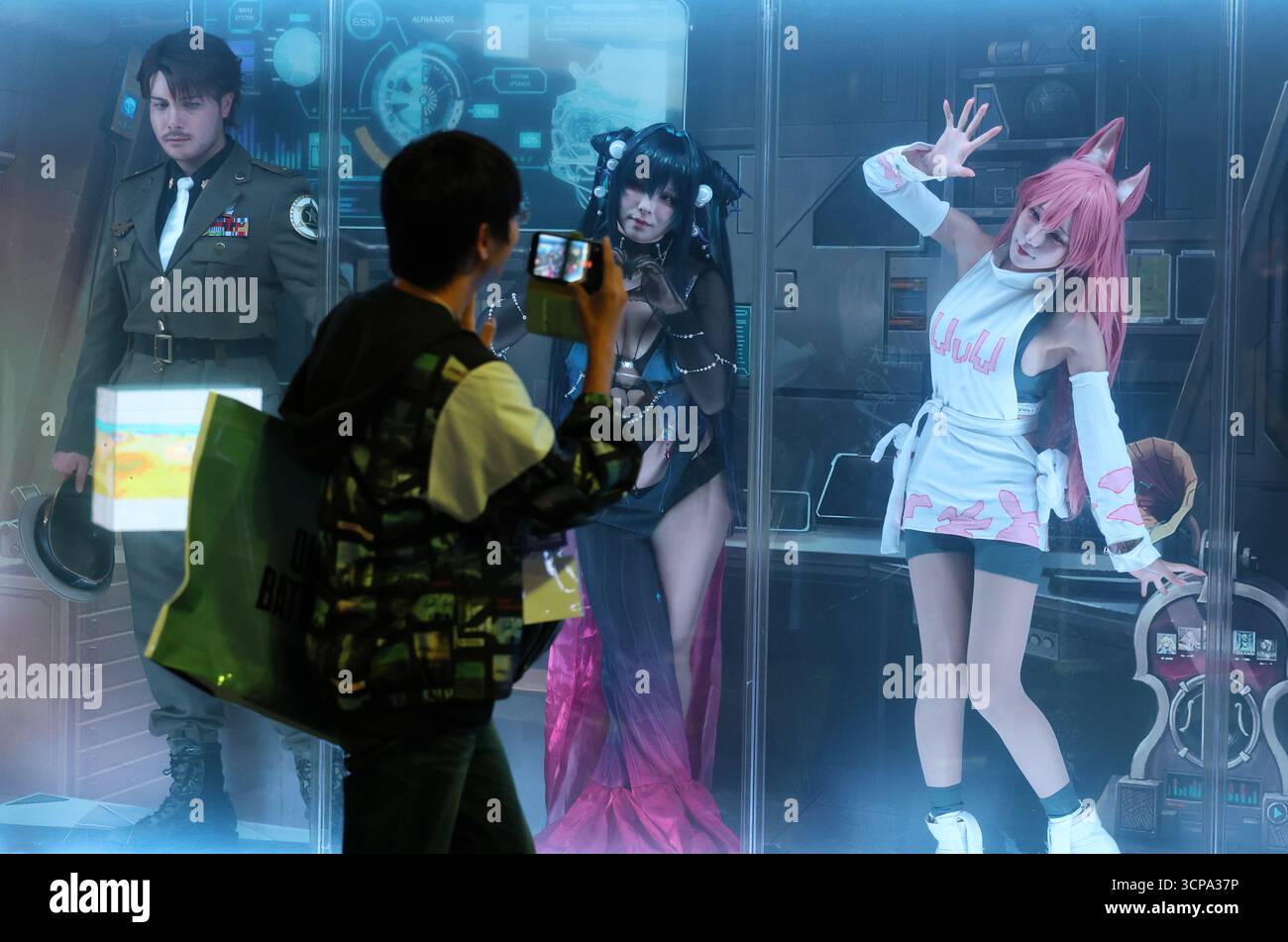 Costume players perform at a booth of a game brand "Level Infinite" at ...
