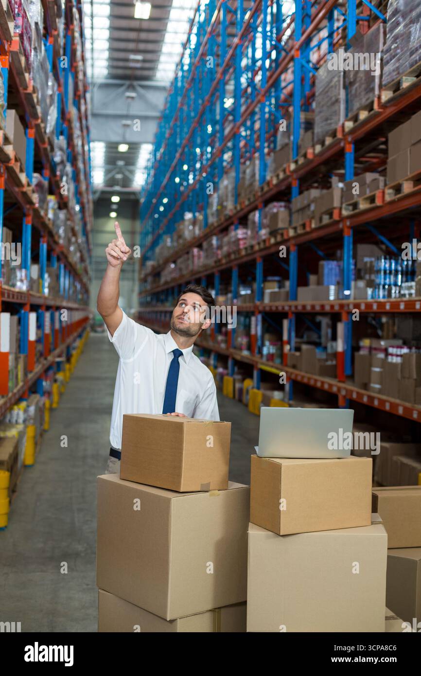 Warehouse manager looking up racks hi-res stock photography and images ...