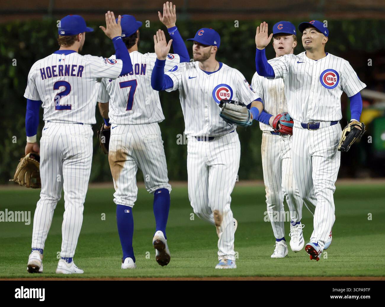 Chicago Cubs players high-five each other after the team's victory over ...