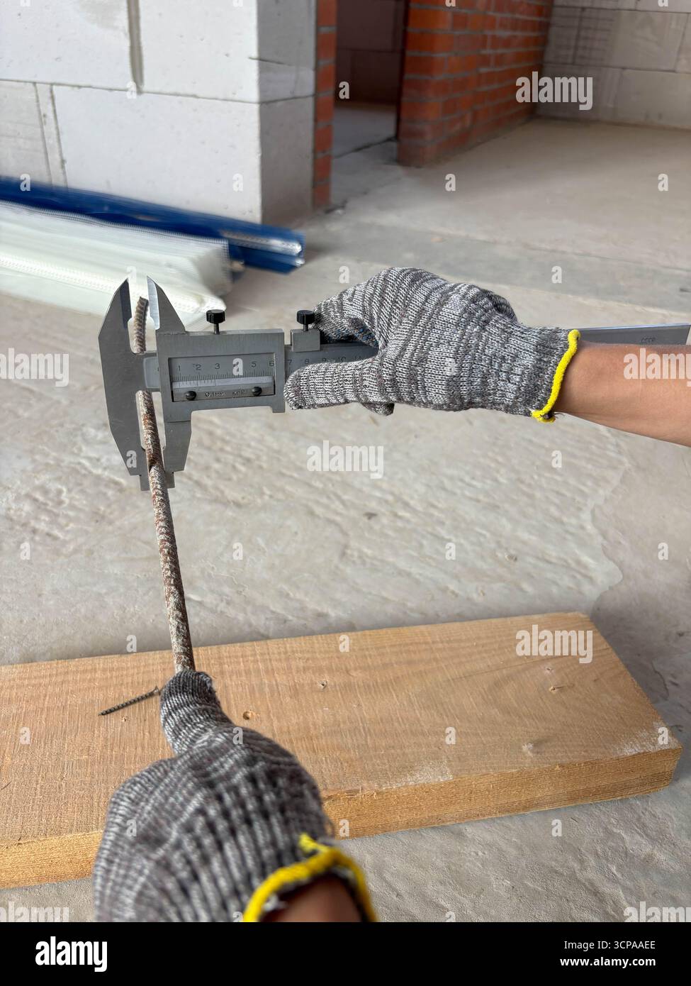 Construction. A metal caliper for measuring the diameter of rebar. A ...
