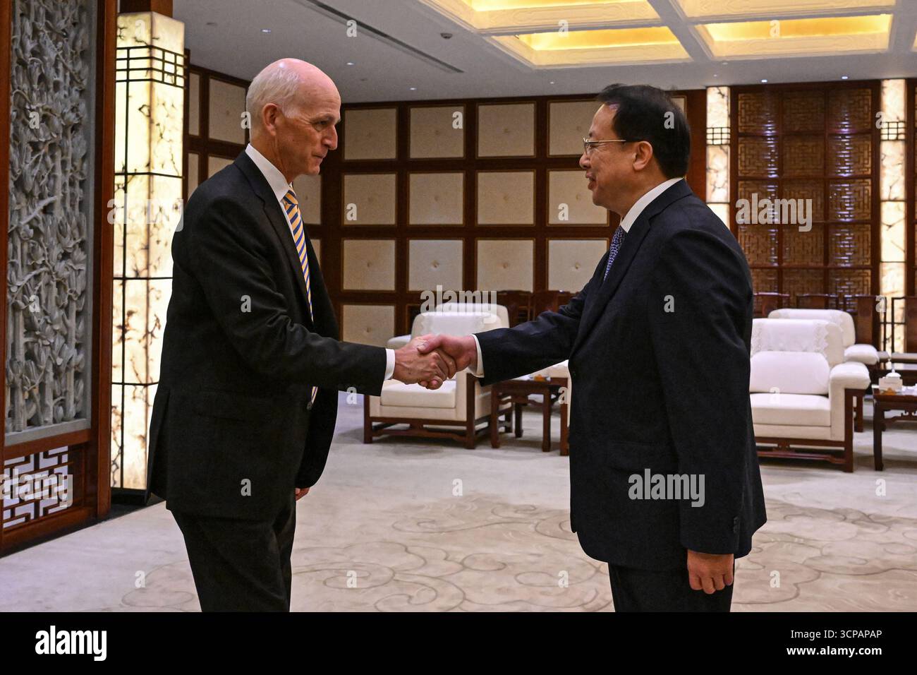 U.S. Representative Adam Smith, left, shakes hands with Shanghai Mayor ...