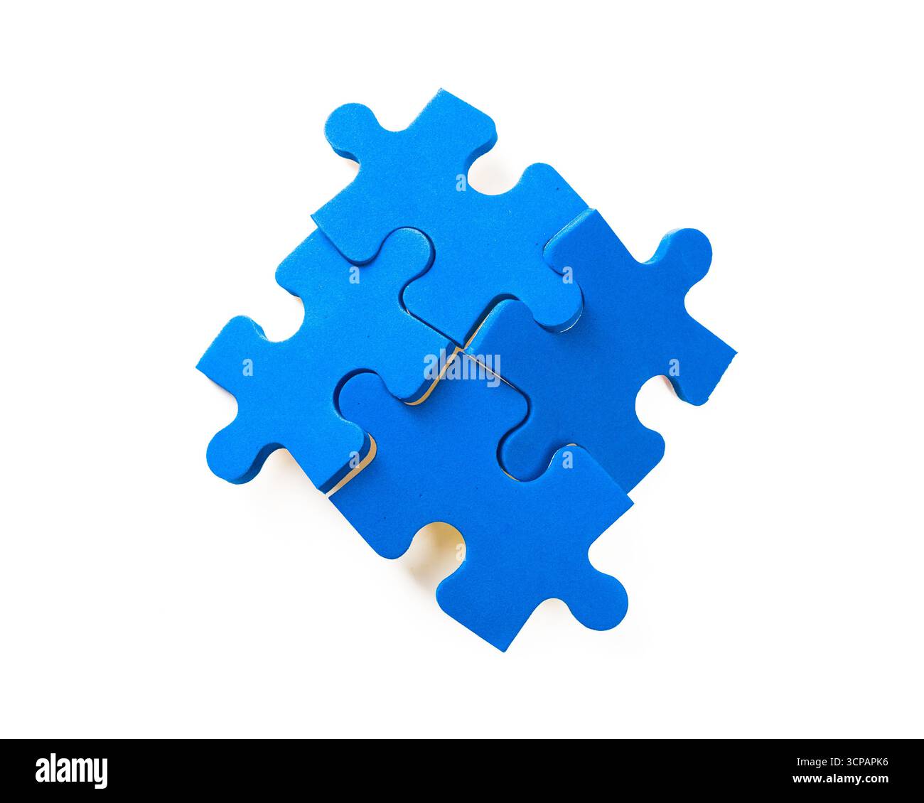 Blue jigsaw puzzle pieces arranged on a white background creating a ...
