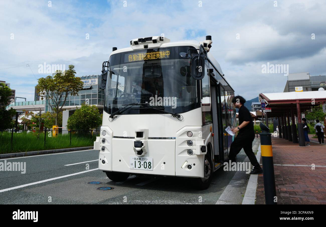 An autonomous driving bus is in operation with passengers on board as a ...