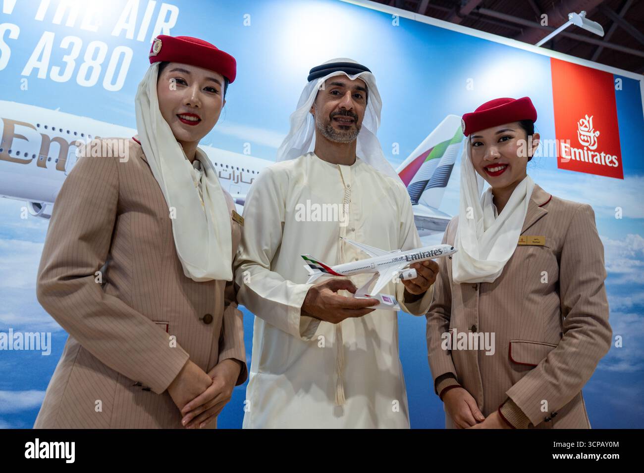 Emirates Staff members holding a model airplane posing for a photo at ...