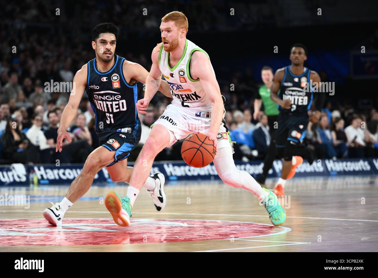 Shea Ili of Melbourne United (left) and Angus Glover of the Phoenix ...