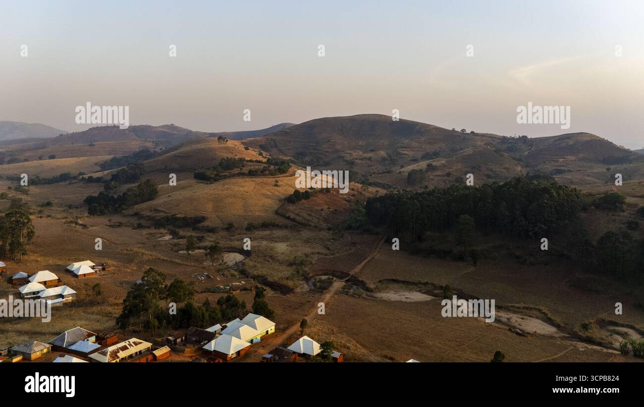 Aerial view of scattered homes nestled amid rolling hills, a tapestry ...