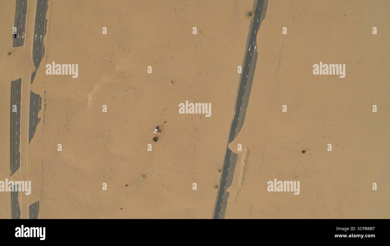 Aerial view of the stark roads cutting through the vast, undulating ...