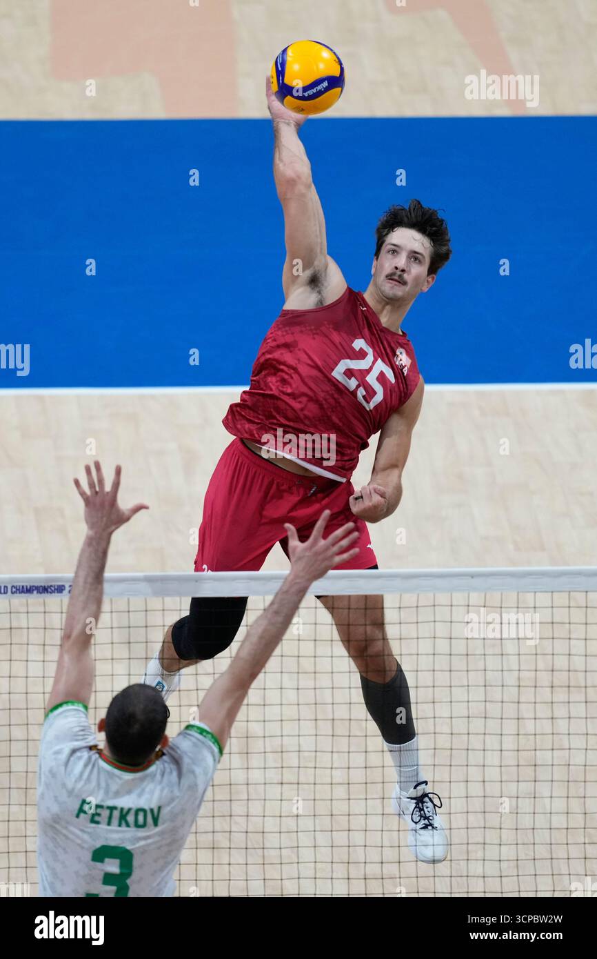 Ethan Champlin of the United States spikes against Iliya Petkov of ...