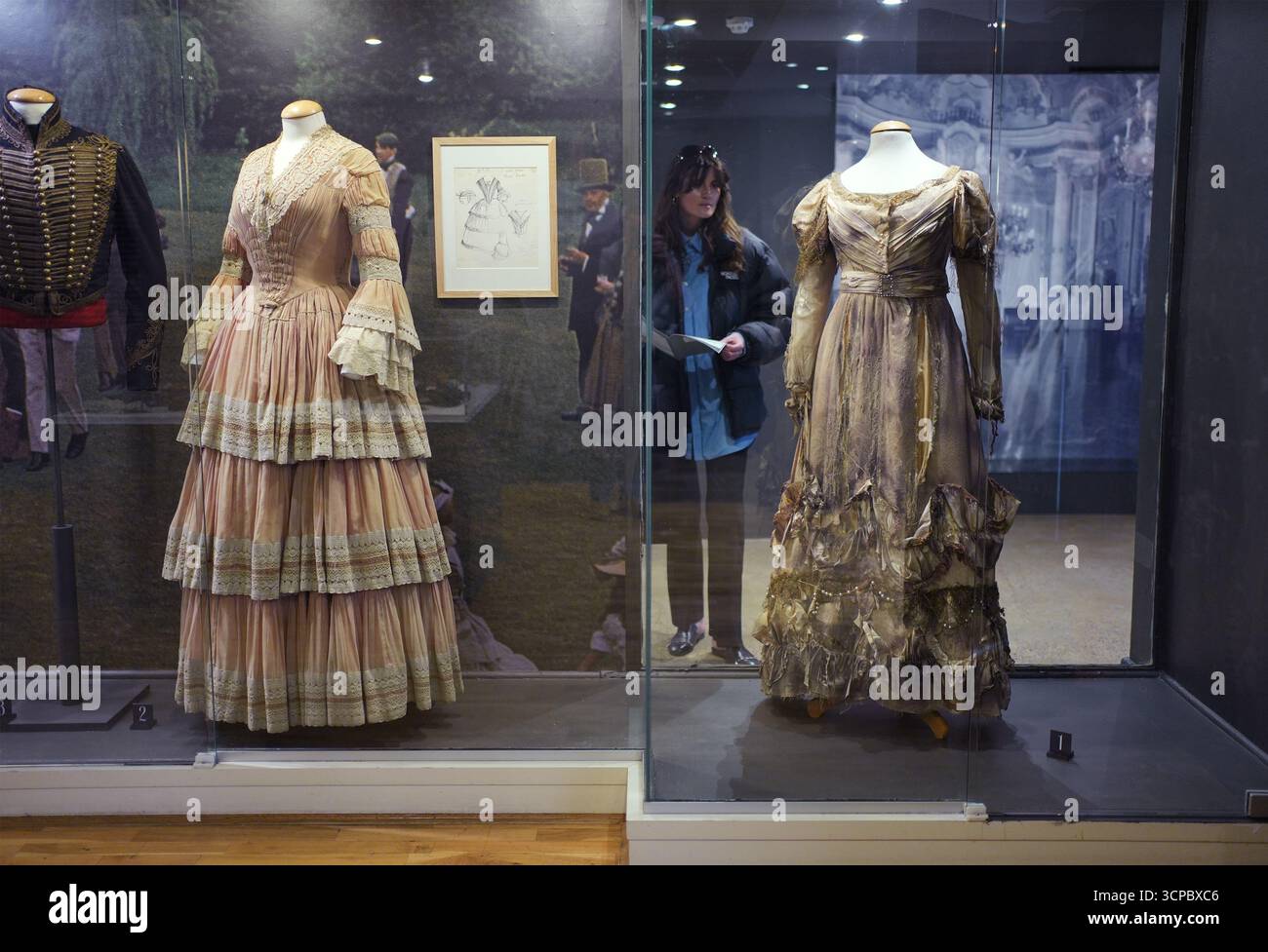 A visitor looking at Miss Havisham's 1820s wedding dress (right), from ...