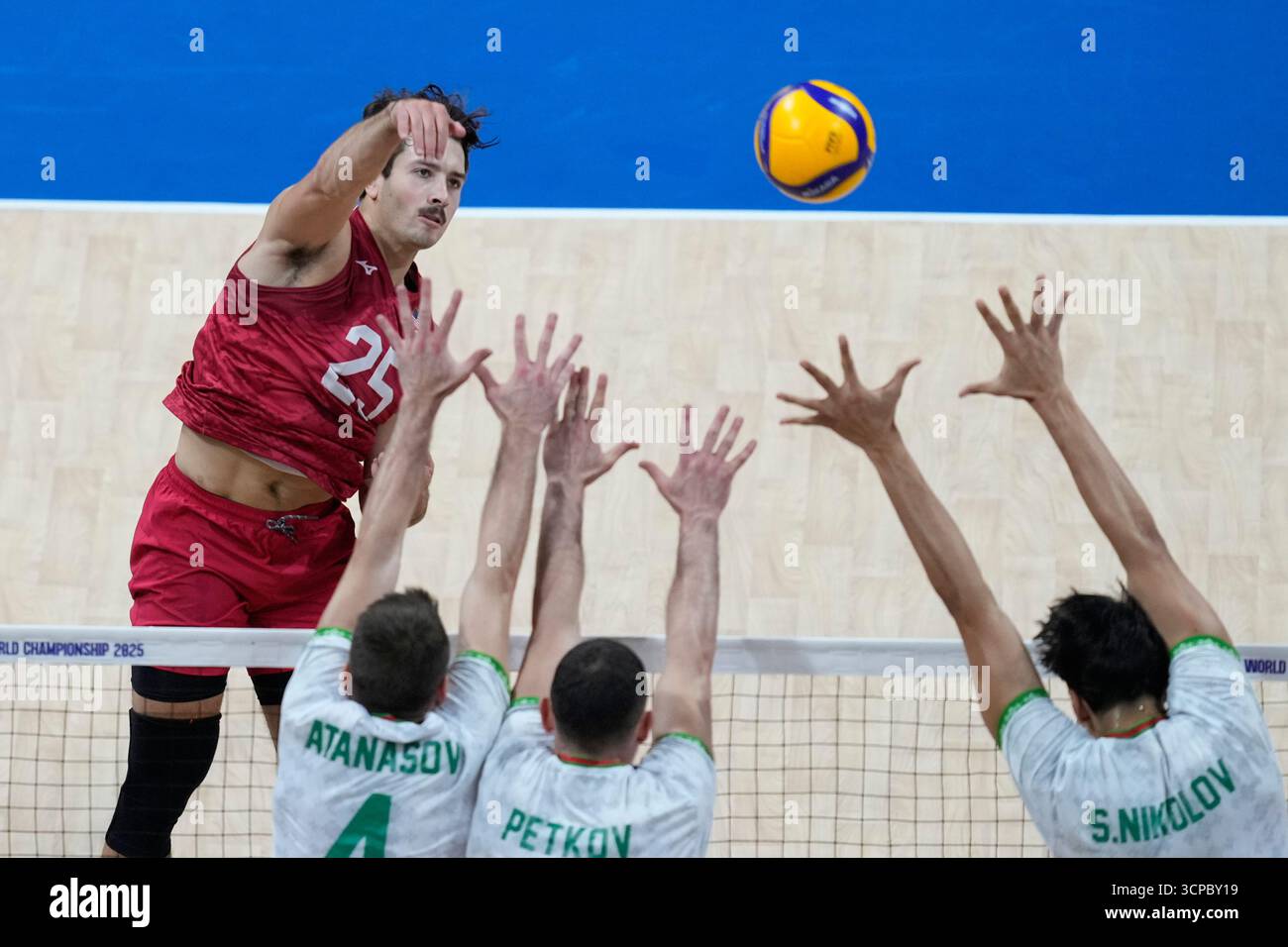 Ethan Champlin of the United States spikes against Bulgaria during ...
