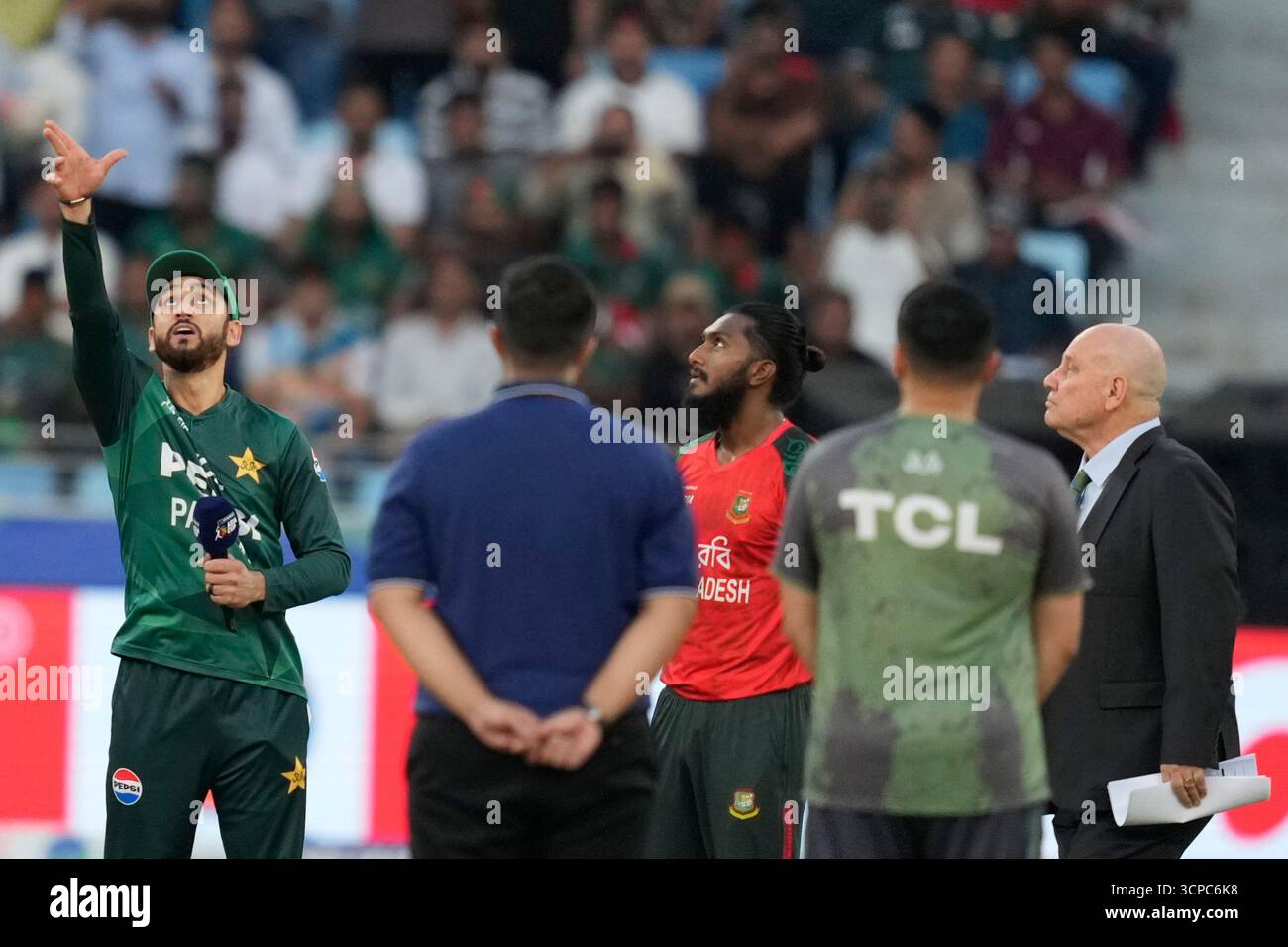 Pakistan's captain Salman Agha, left, toss a coin during the Asia Cup ...