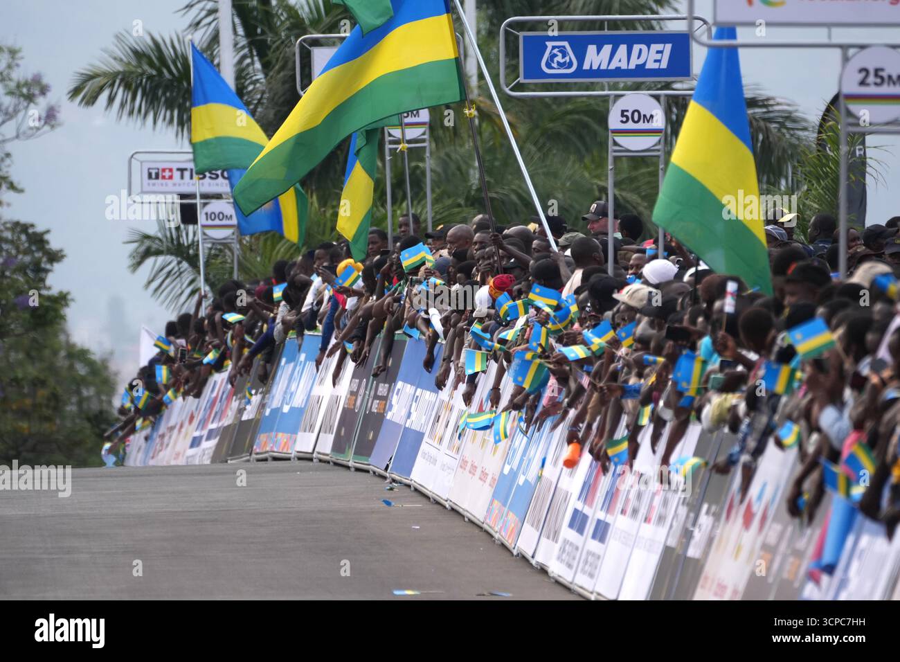 Spectators wait for the cyclists to pass by during the women's Under 23 ...