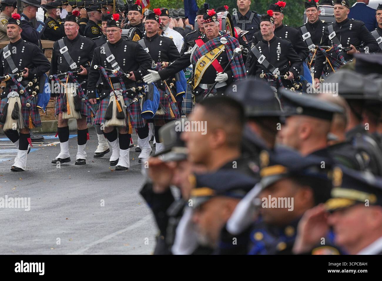 Officers watch a procession for slain Northern York County Regional ...