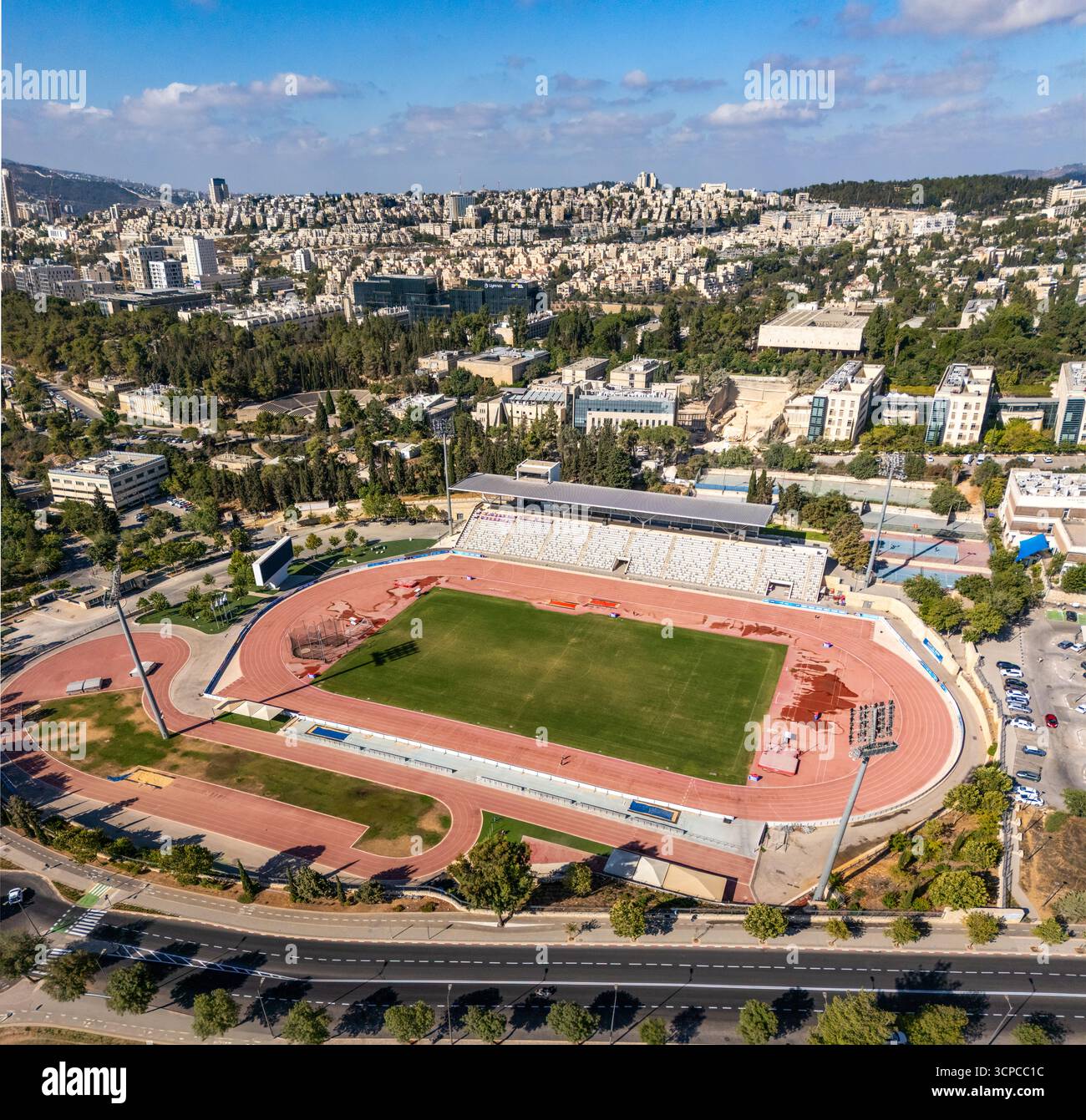 Aerial view of the Givat Ram Stadium nestled amid lush greenery and ...