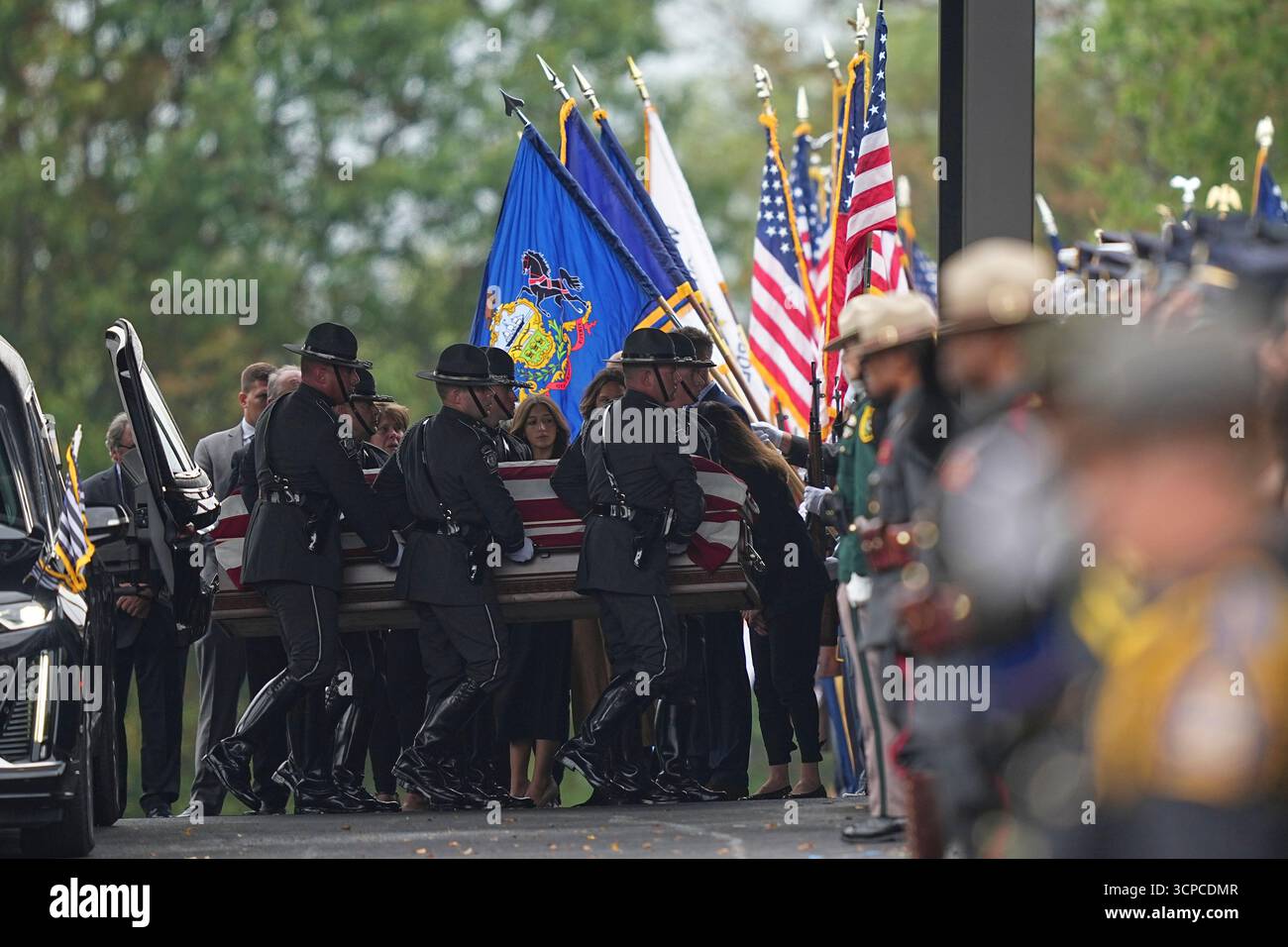 Pall bearers carry the coffin of a slain officer during funeral services for Northern York ...