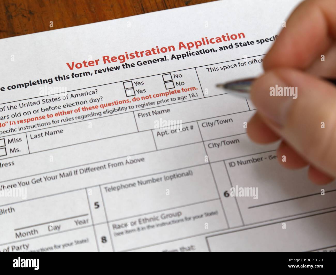A voter registration form paper copy in the USA is shown up close, with ...