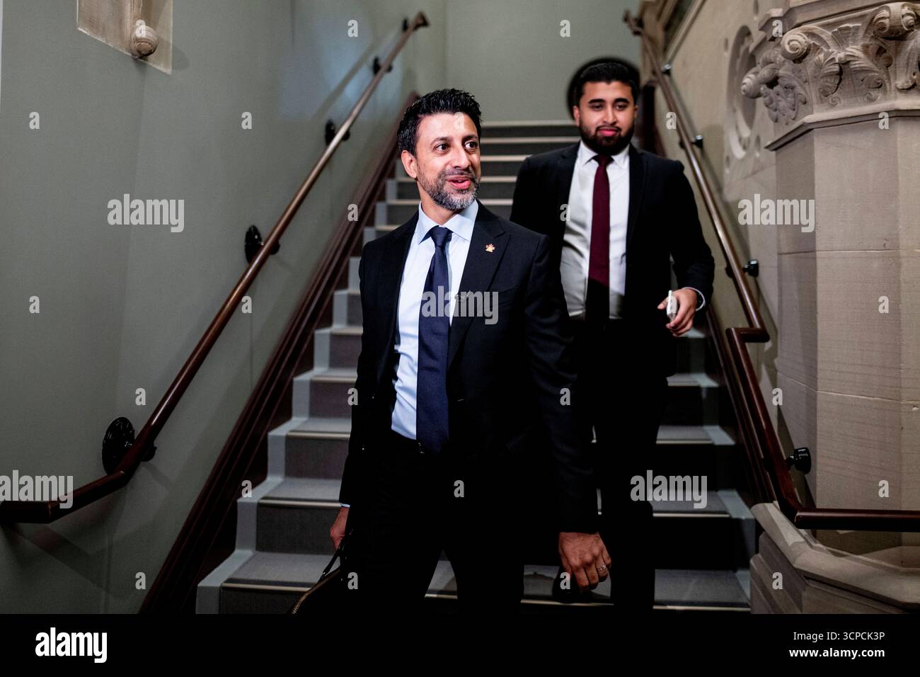 Minister of International Trade Maninder Sidhu makes his way past ...