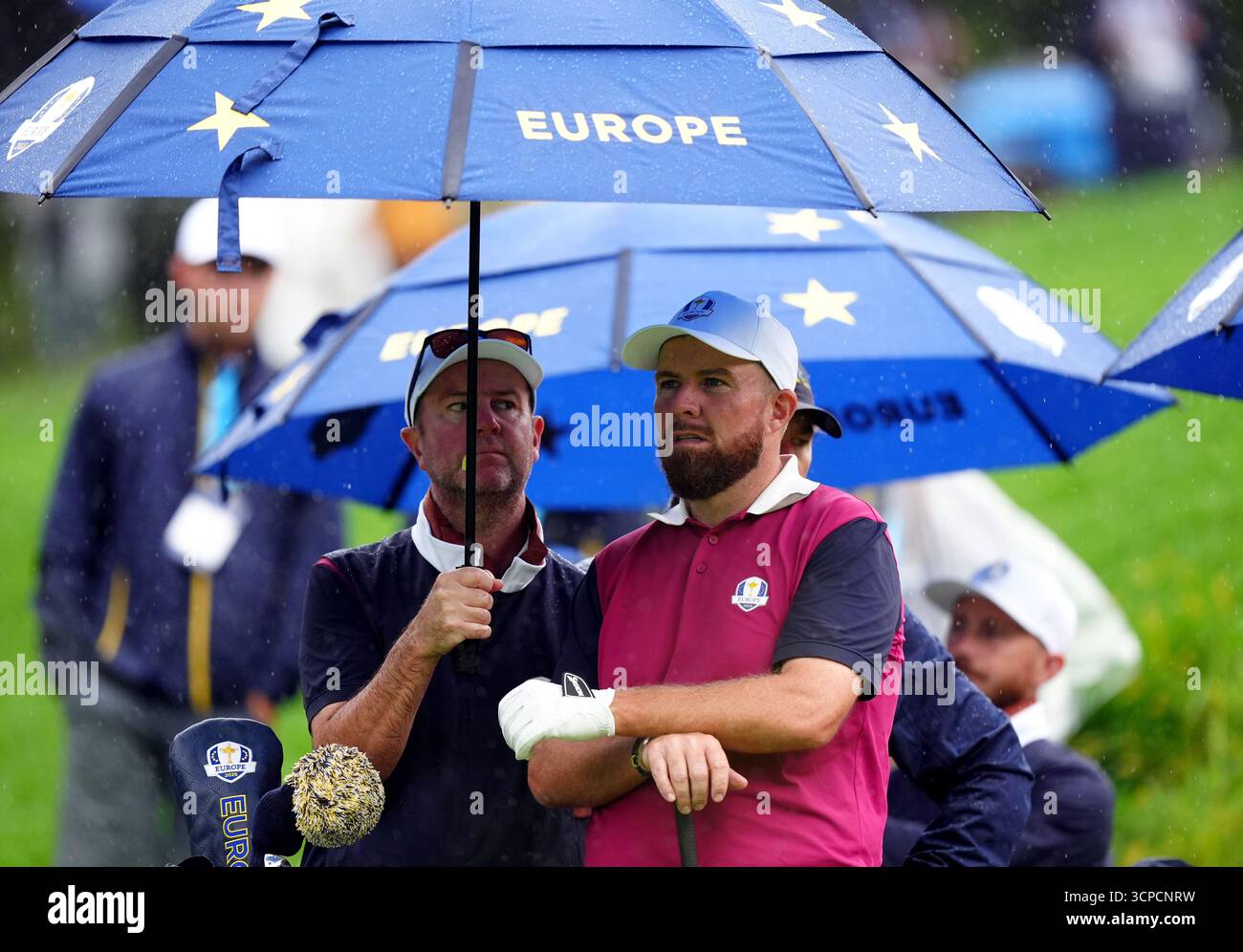 Shane Lowry of Team Europe shelters from the rain during a practice ...