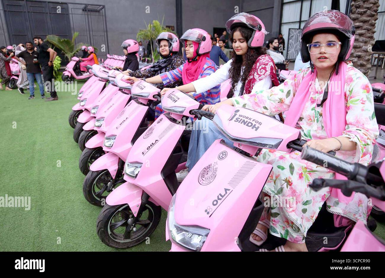 Female applicants along the Pink EV Scooty during Distribution Ceremony ...
