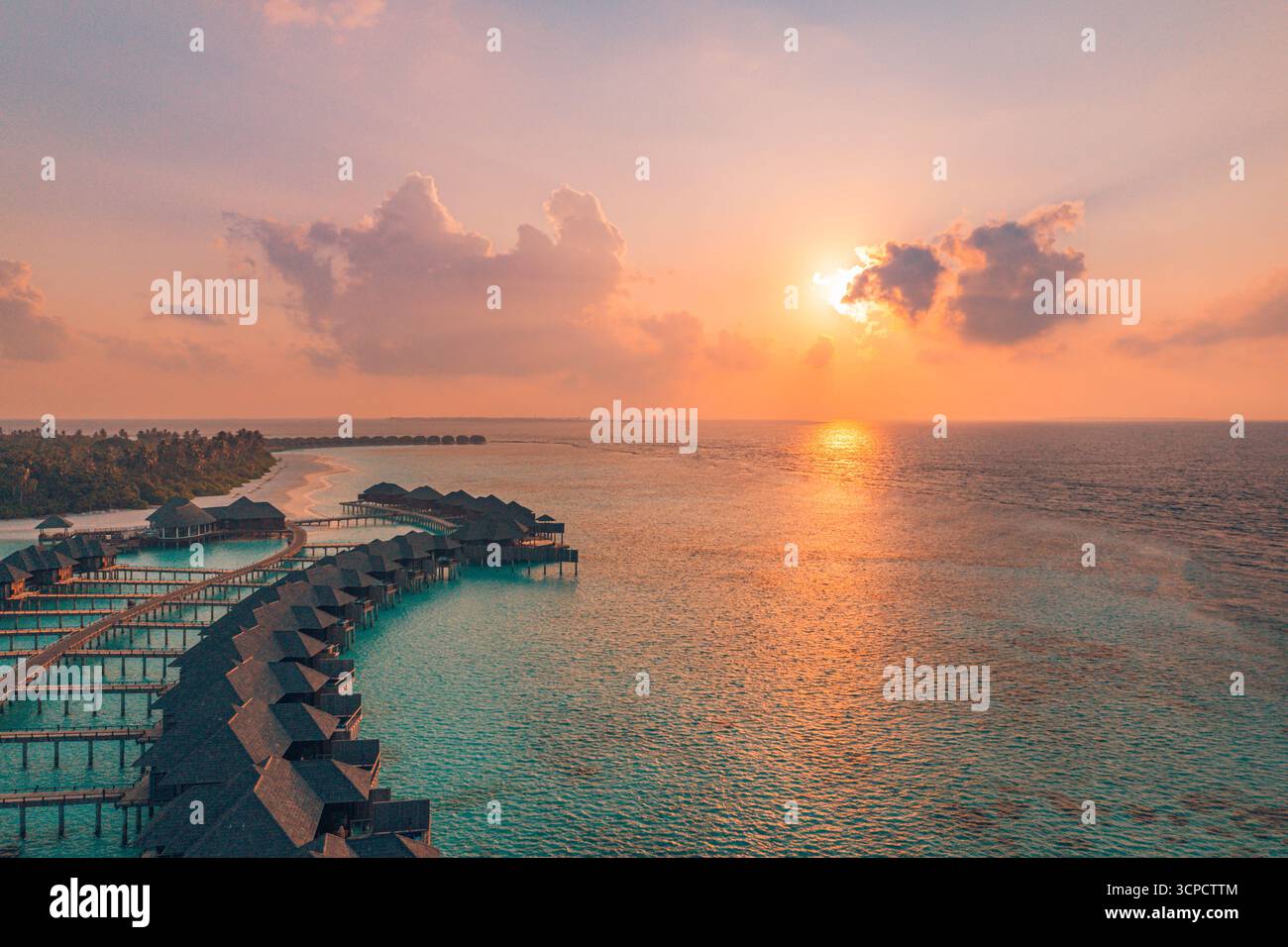 Fantastic aerial sunset sky clouds view of luxury Maldives resort ...