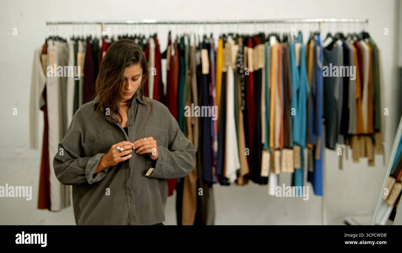 A Fashion Model is Organizing her Wardrobe in a Professional Studio ...